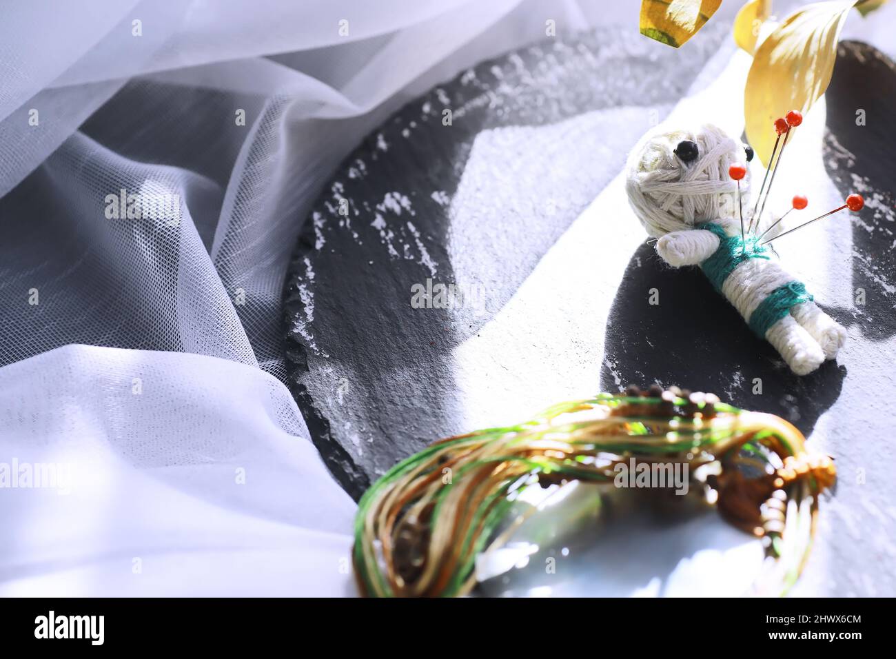Voodoo Doll on a stone background with dramatic lighting. Mystic still ...