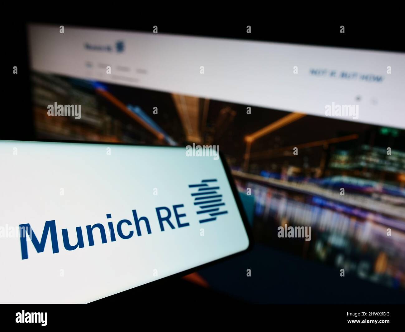 Cellphone with logo of German insurance company Munich Re Group on ...
