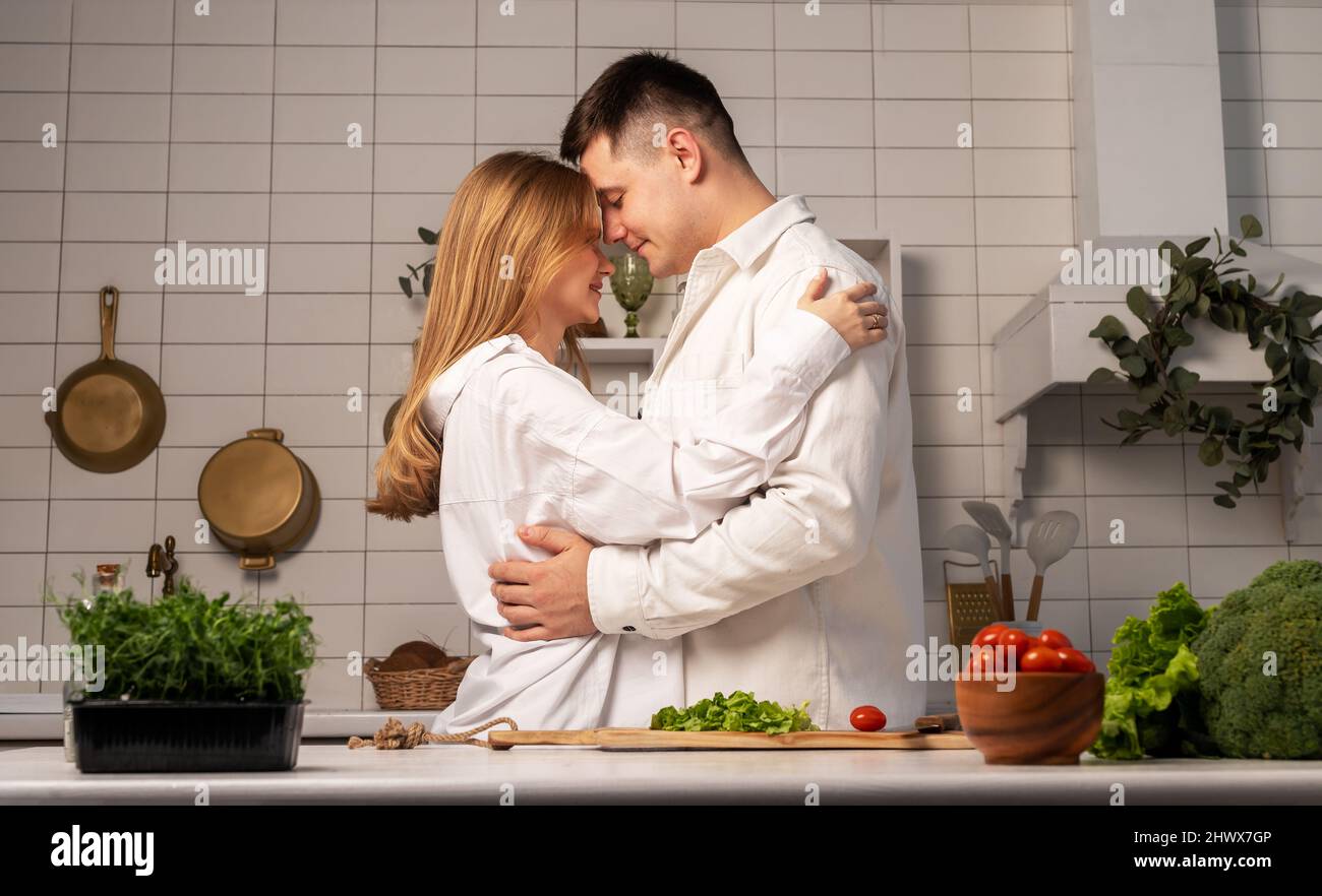 Handsome man hugging beautiful woman hi-res stock photography and ...