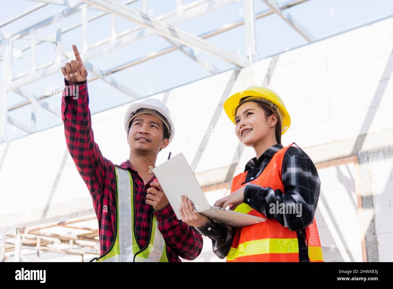 Asian engineer foreman worker man and woman working at building ...