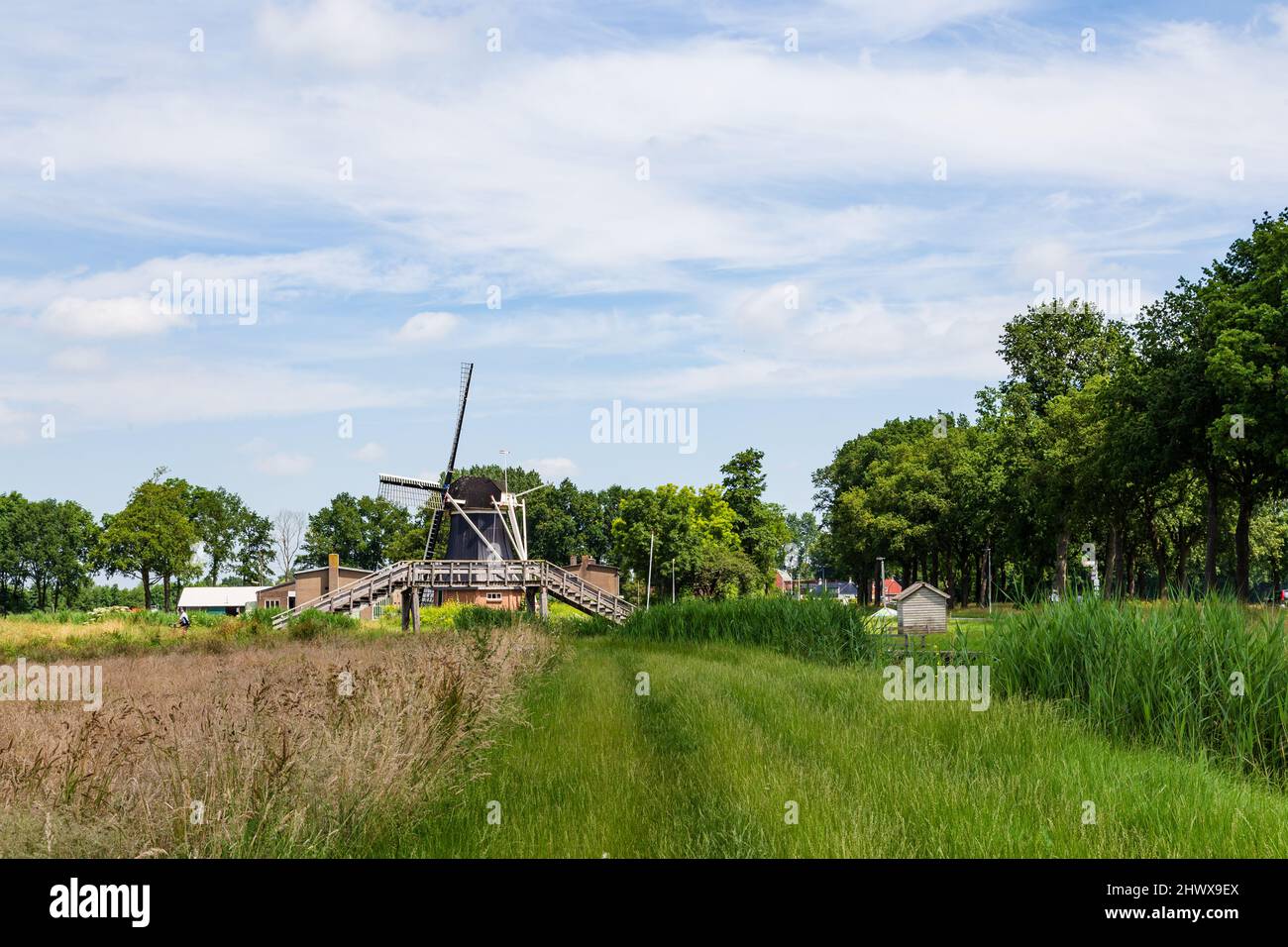 Sunny windmill and bridge landscape De Groeve near Zuidlaren in Drenthe ...