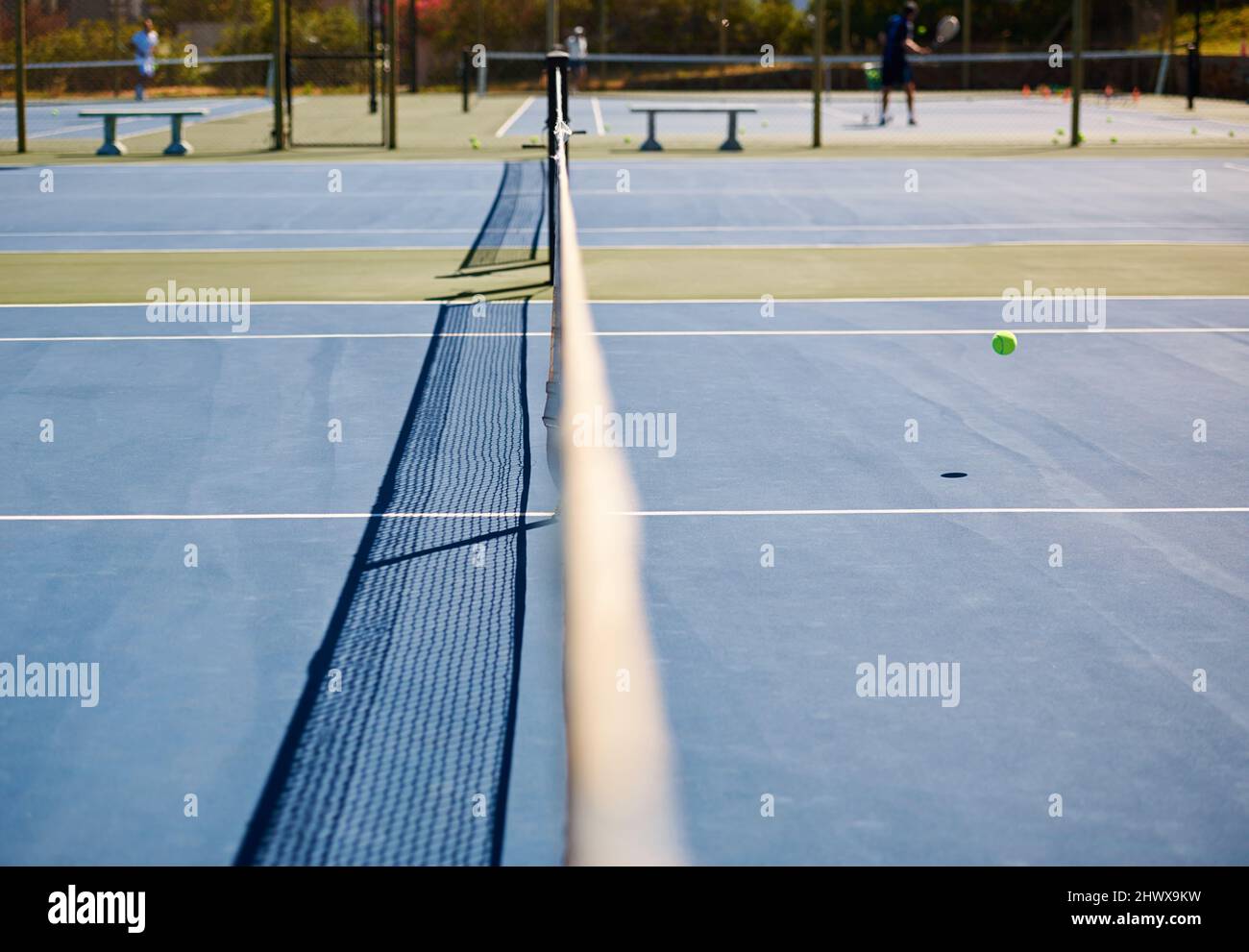 Hitting the ball over the net. A tennis court Stock Photo - Alamy