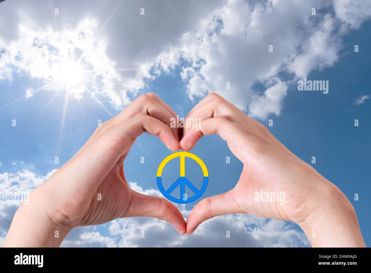 Hands showing the shape of a heart and a sign of peace toned in the ...
