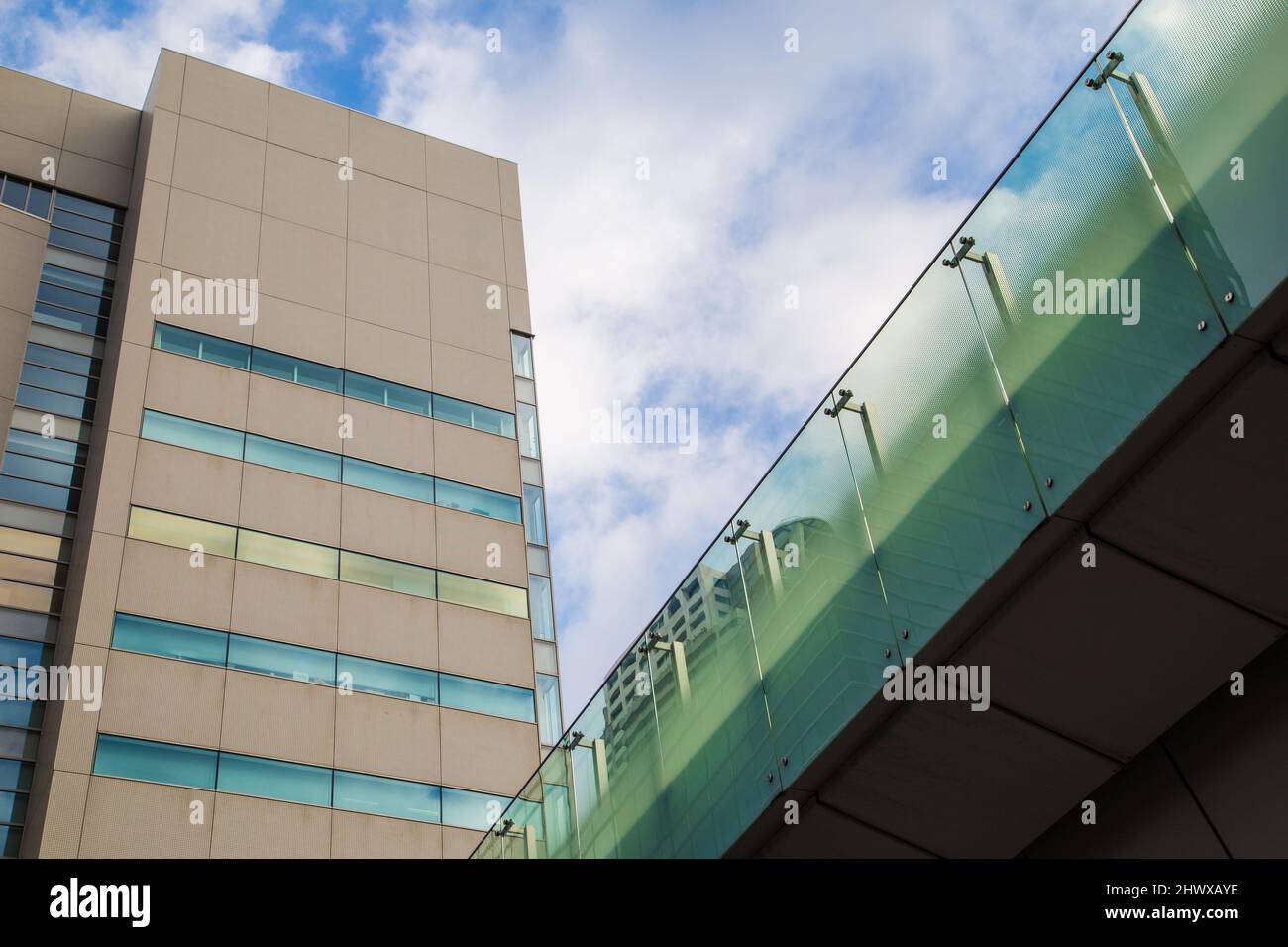 Window office building in Tokyo city against blue sky with cloud uprise ...
