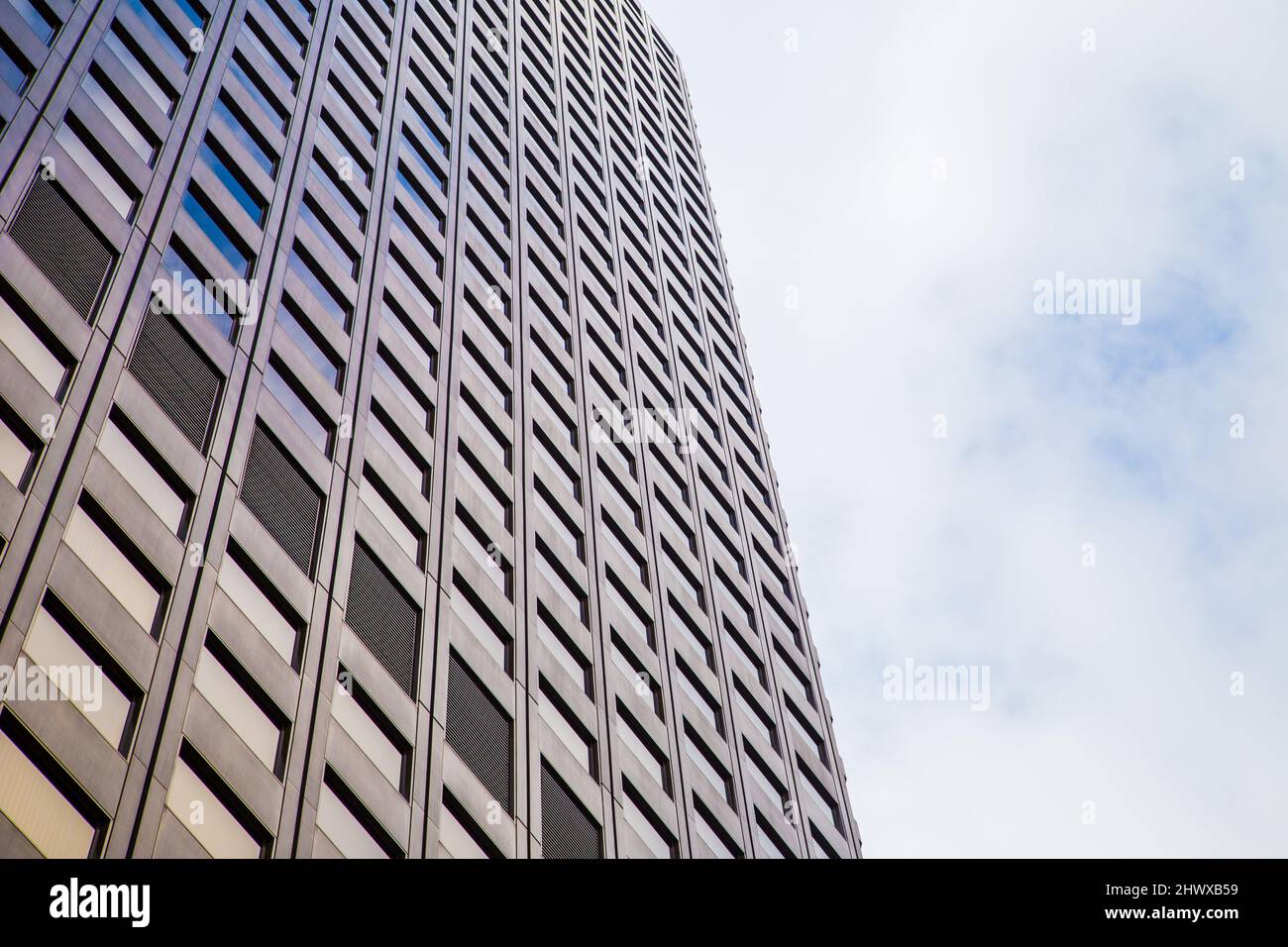 Window office building in Tokyo city against blue sky with cloud uprise ...