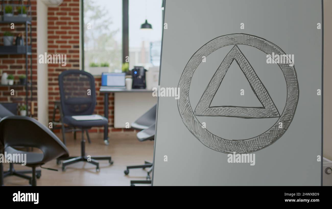 Close up of white board with aa meeting symbol and chairs in empty ...