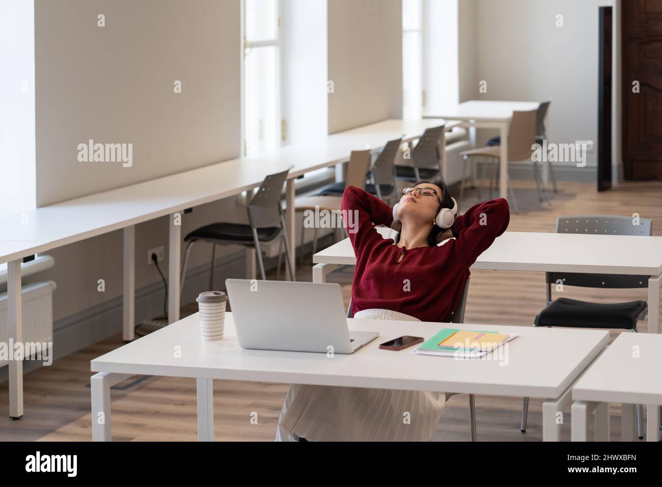 Calm asian girl student with closed eye listen music rest from exam ...