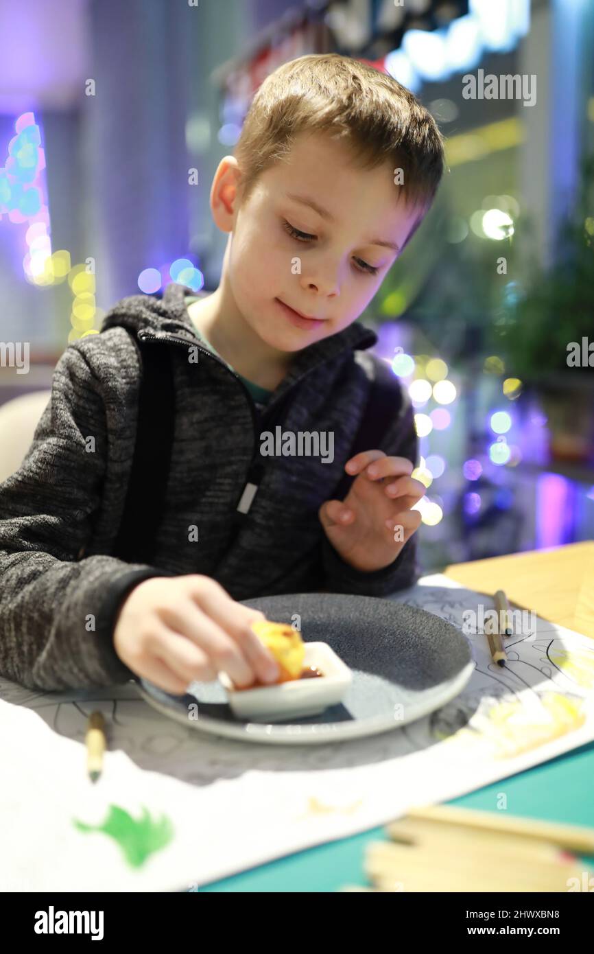 Child eating sushi with hands in asian restaurant Stock Photo - Alamy