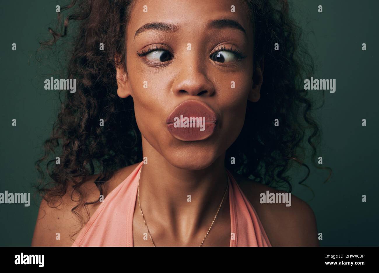 Squishy kisses. Cropped shot of an attractive and quirky young woman ...