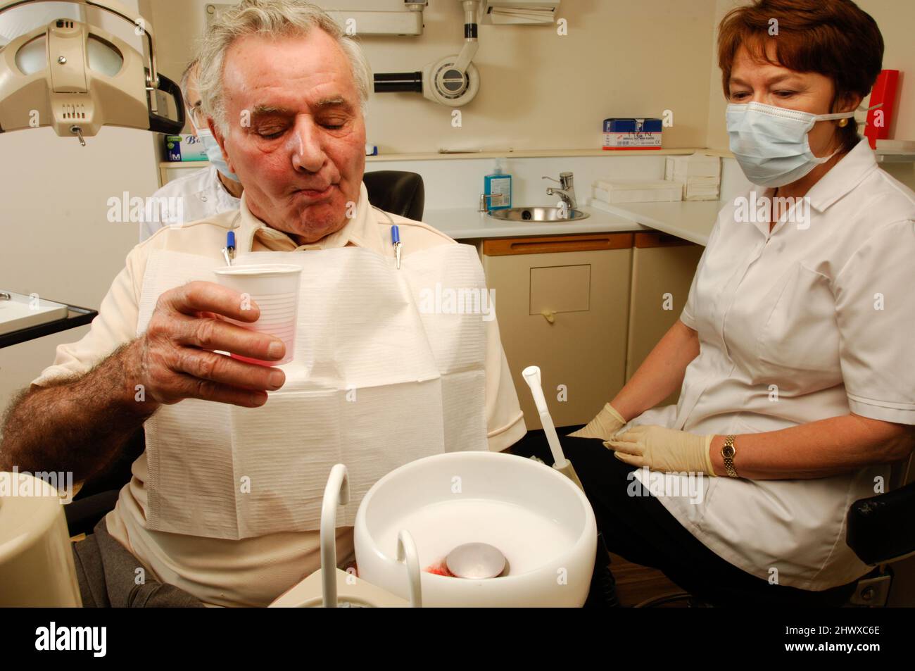A man rinsing his mouth out after having a tooth removed.(MODEL ...