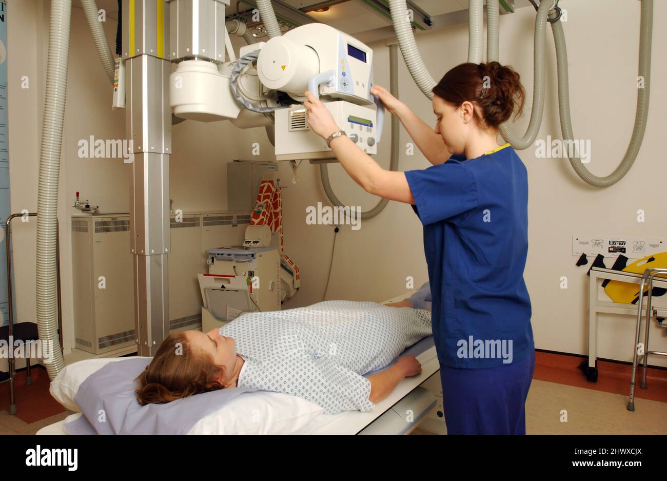 The Radiologist Sets up the imaging control unit aiming the light on ...