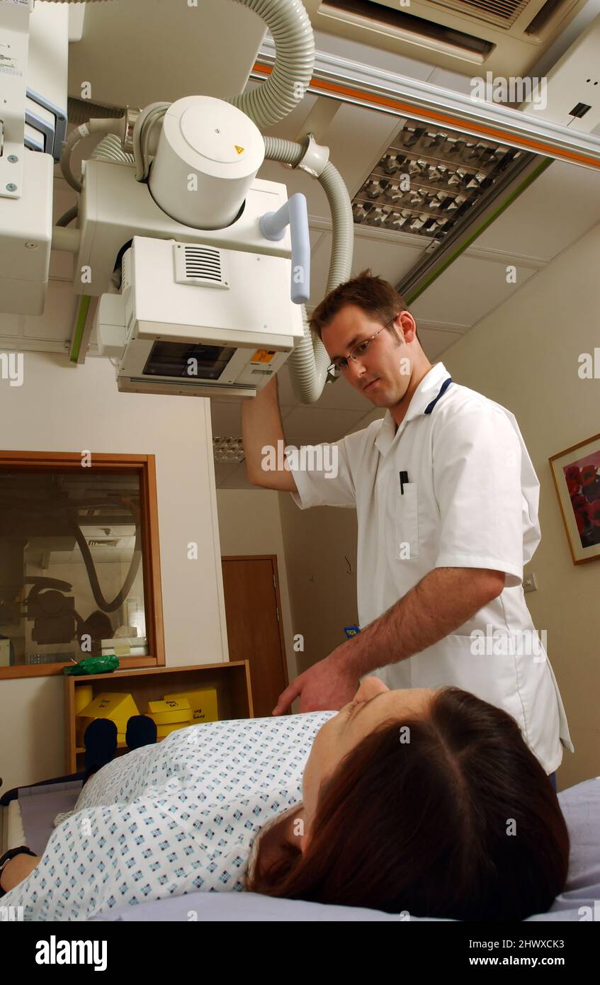 A radiologist Sets up the imaging control unit aiming the light on the ...