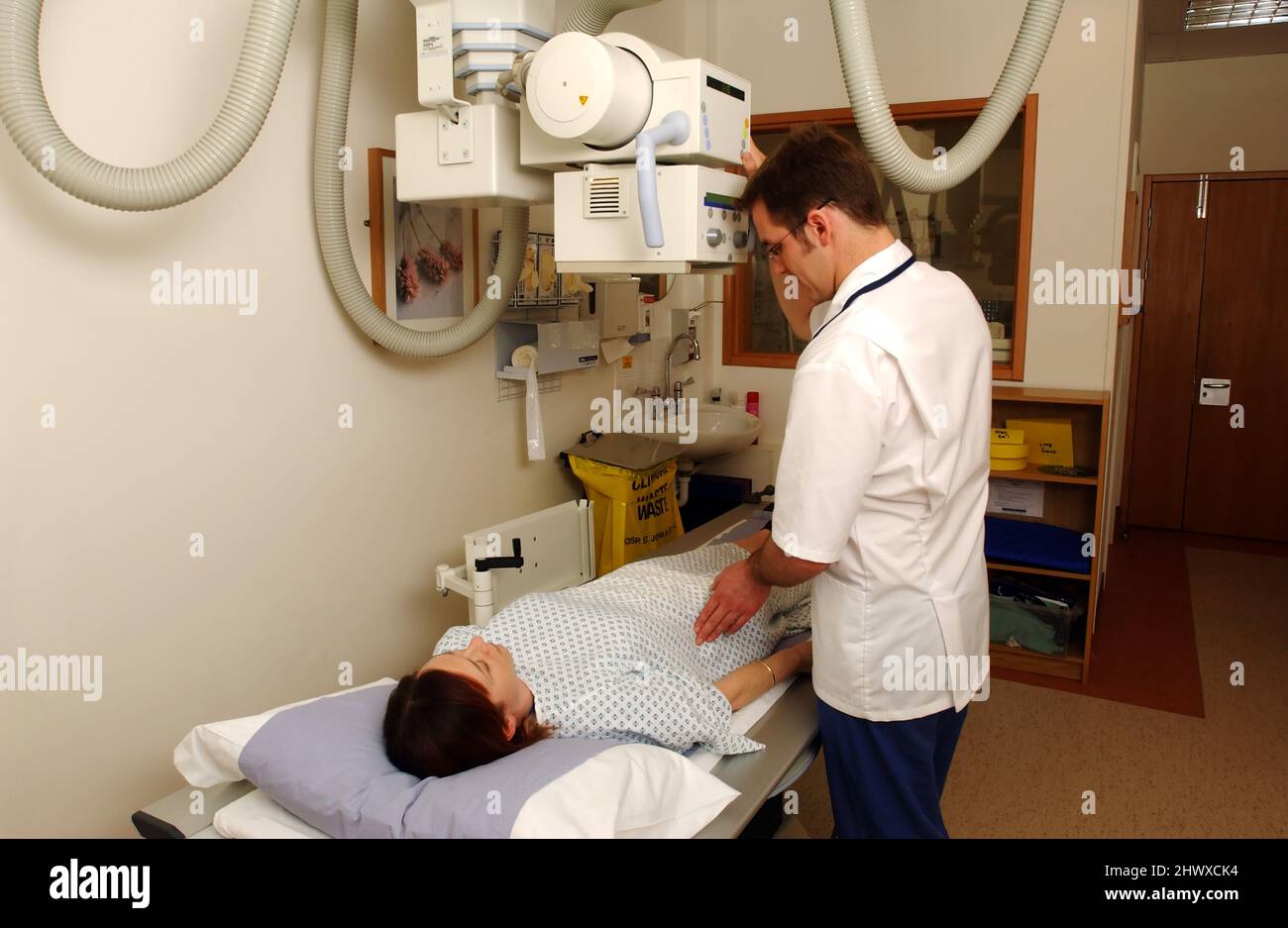 The Radiologist Sets up the imaging control unit aiming the light on ...