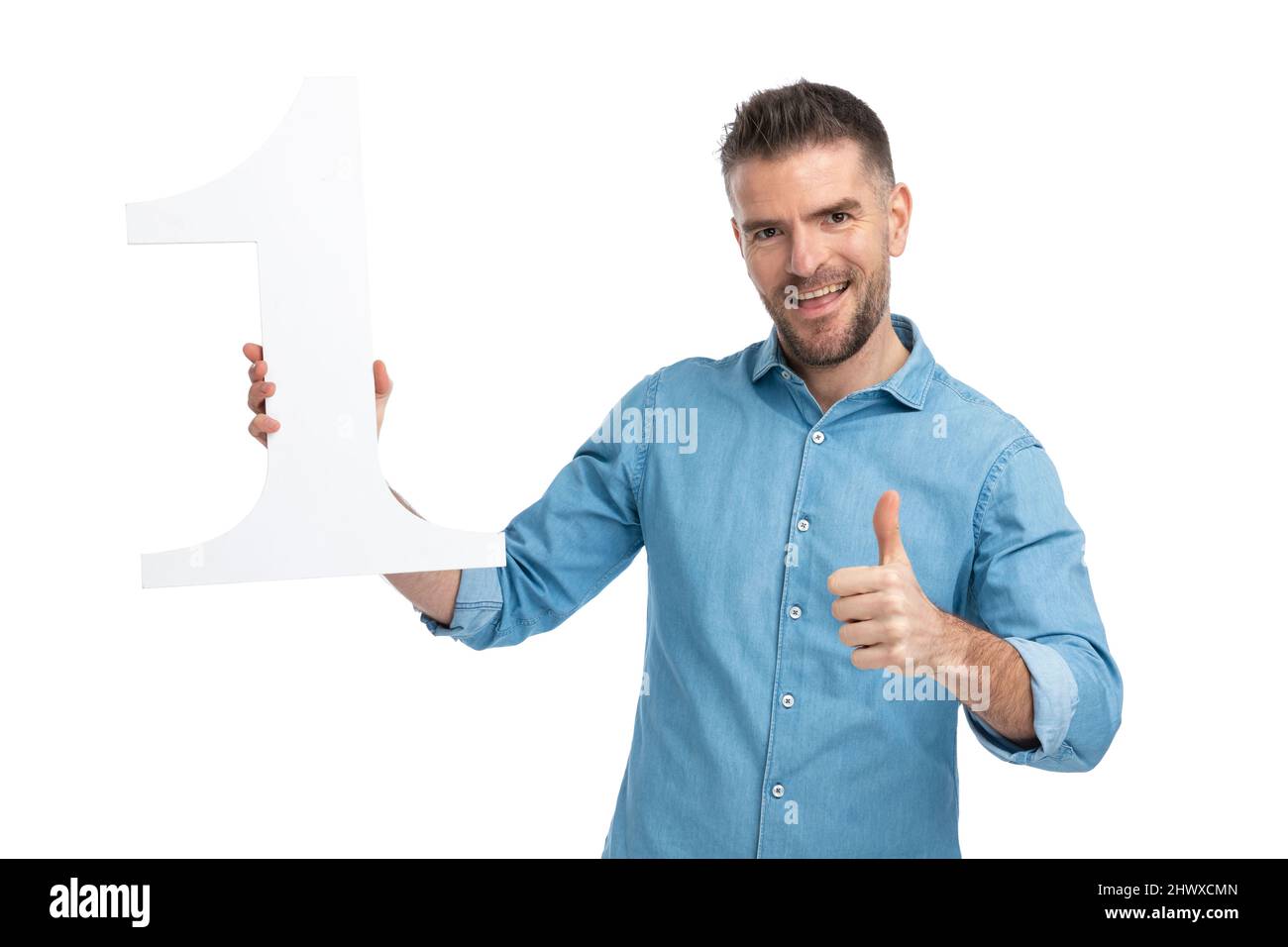 bearded guy holding number one and making thumbs up gesture and smiling ...