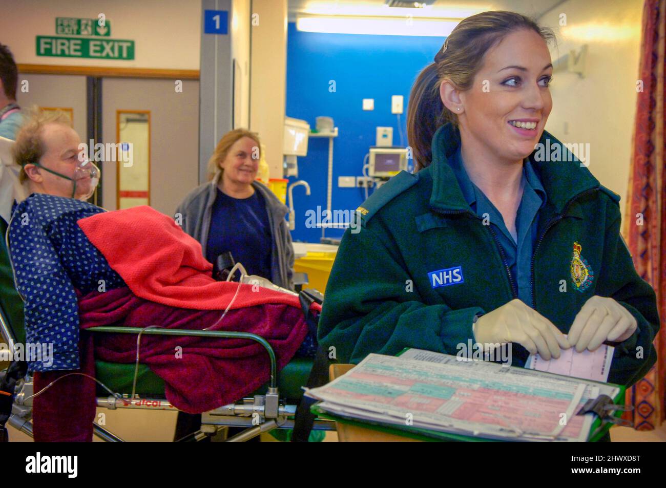 An paramedic 'books' a bed ridden patient into hospital.(MODEL RELEASED ...