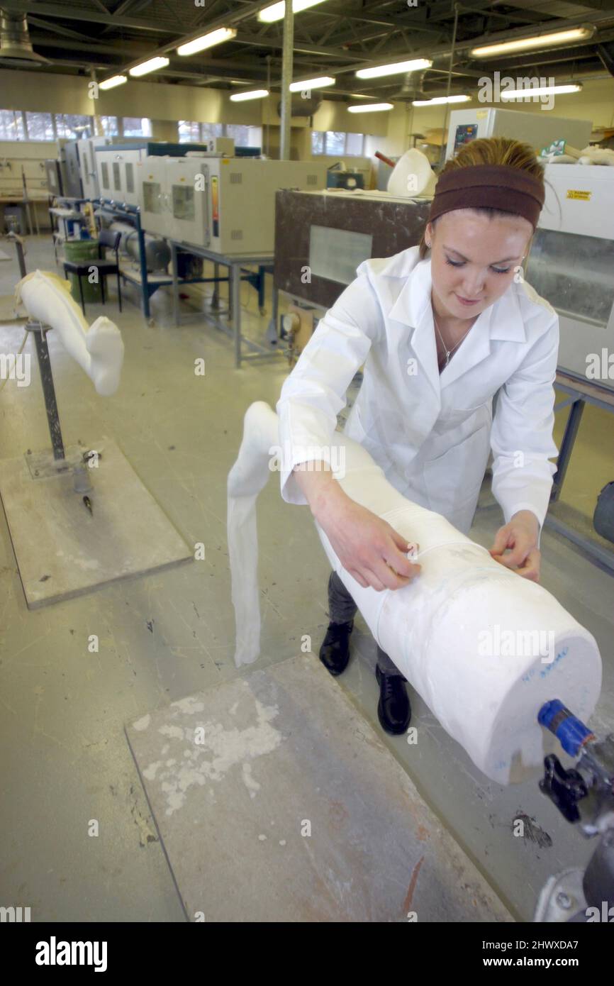 A female technician completes the plastic moulding of a plaster cast ...