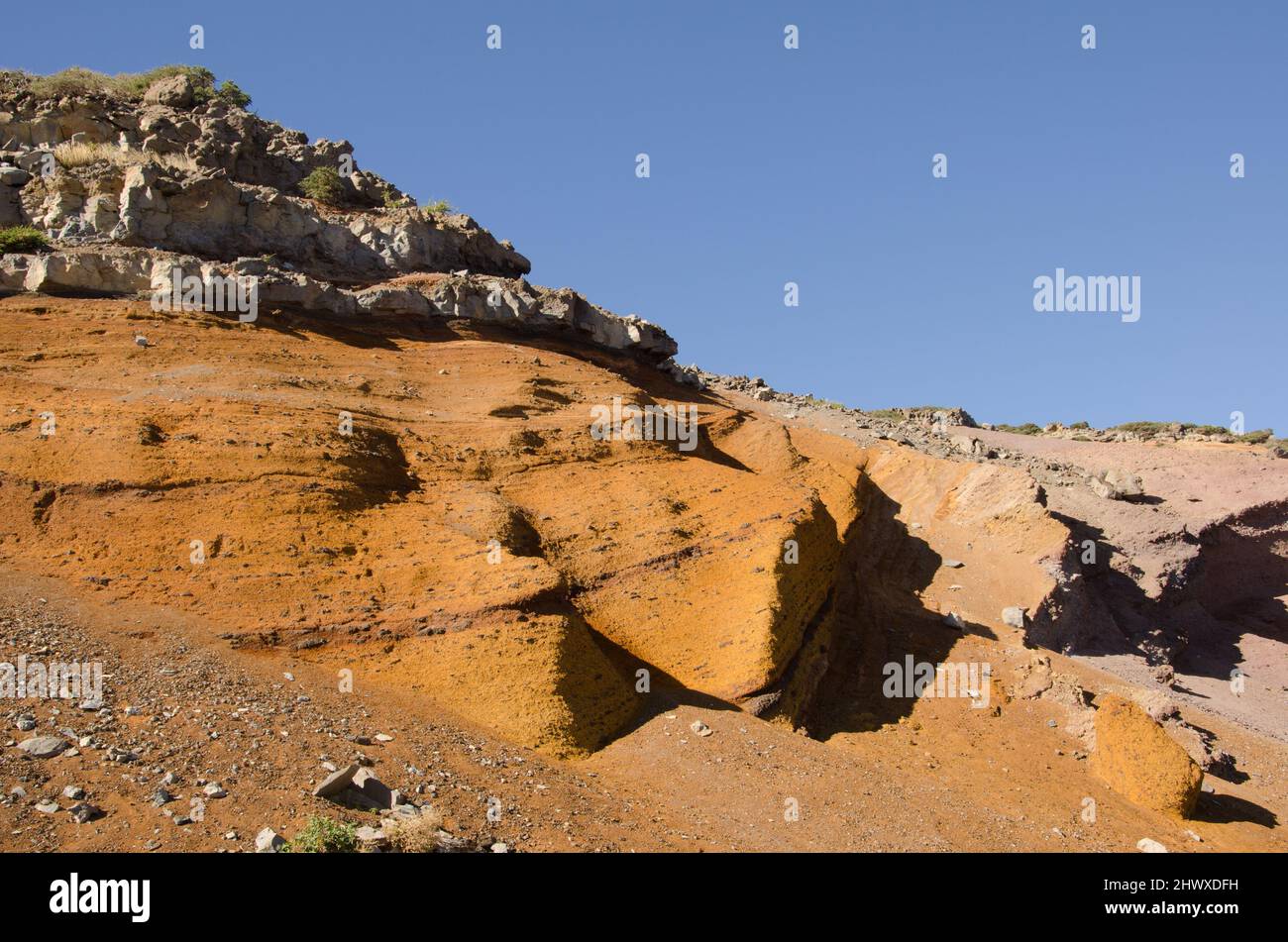 Cliff with volcanic tuff in its lower part and basaltic rock in the ...