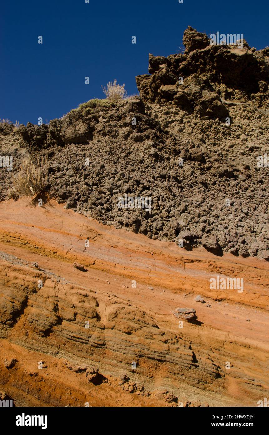 Cliff with volcanic tuff in its lower part and basaltic rock in the ...