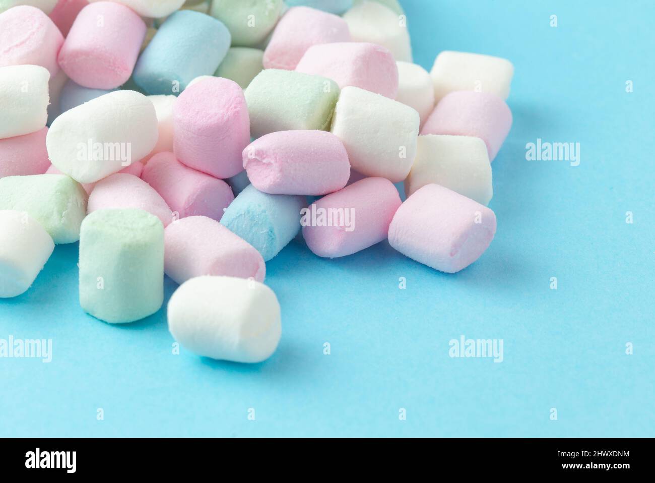 Colorful marshmallows on soft blue background Stock Photo - Alamy