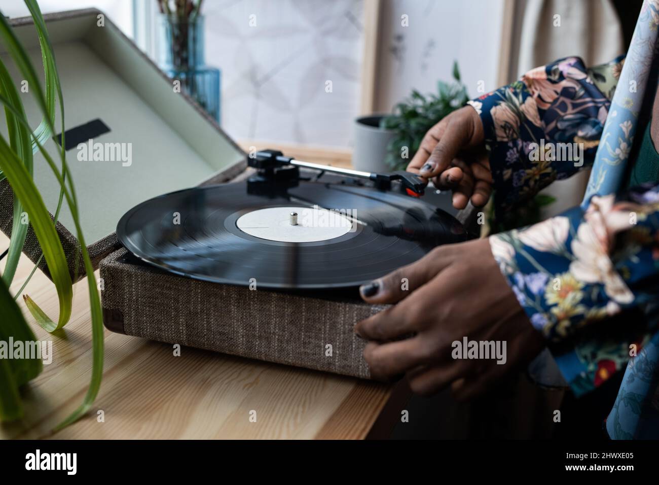 Hands of young black man with nail polish putting vinyl record on ...