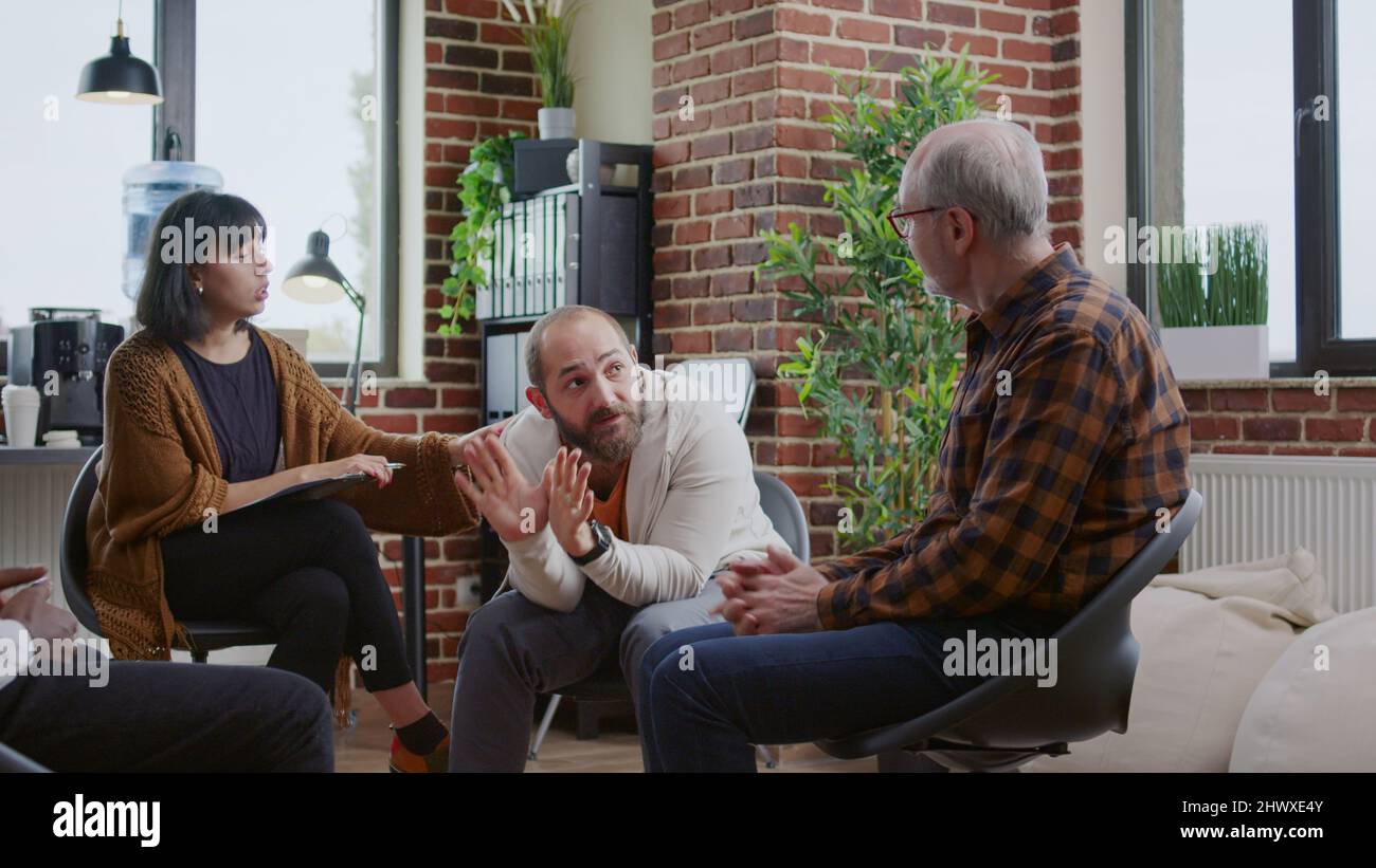 Person having anger crisis in front of people at aa group therapy ...