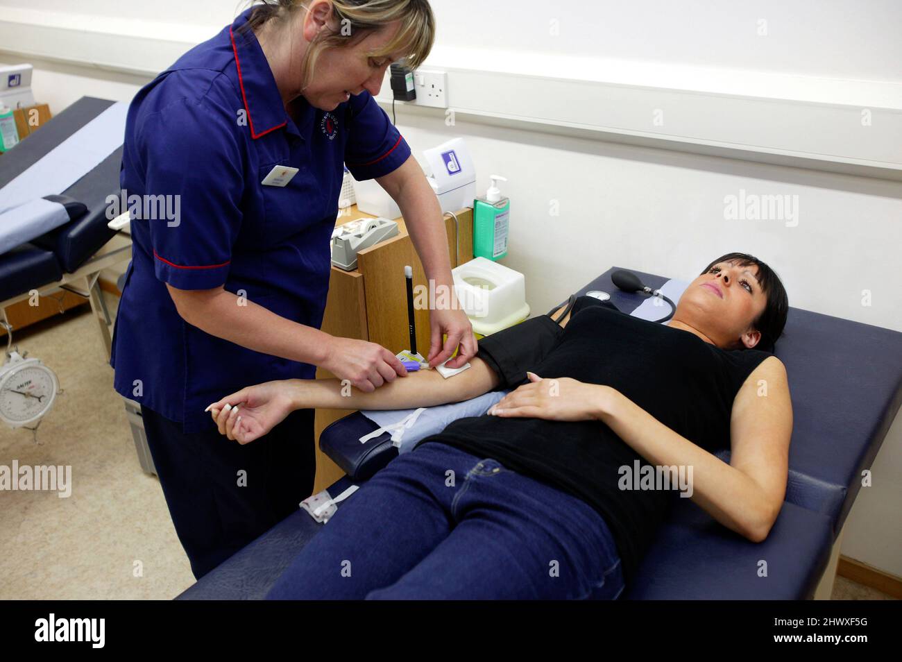 A National Blood Service, nurse collects a blood sample from a female ...