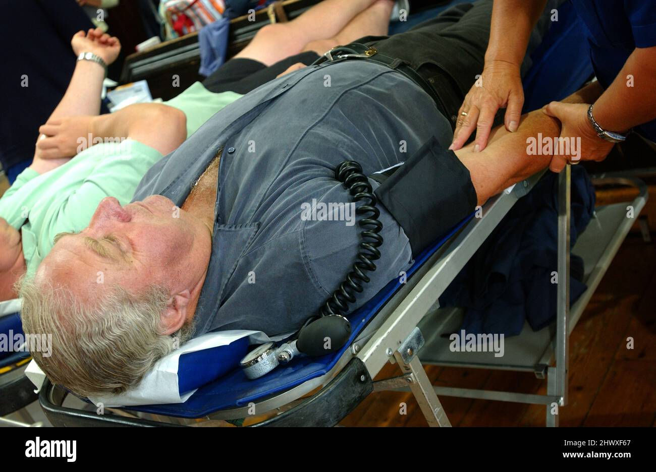 An elderly man about to donate blood in a NHS National Blood Service ...