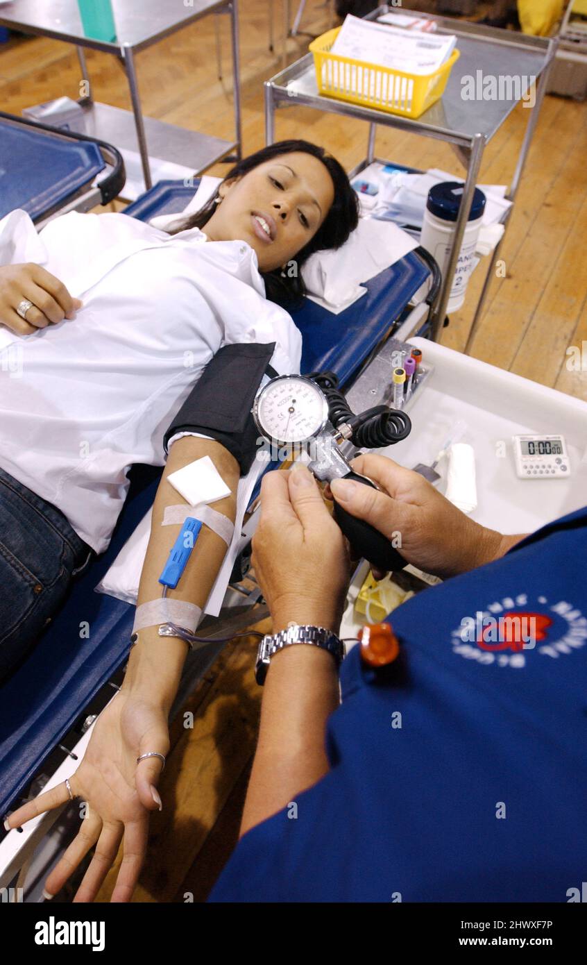 NHS National Blood Service nurse checks the blood pressure of a young ...