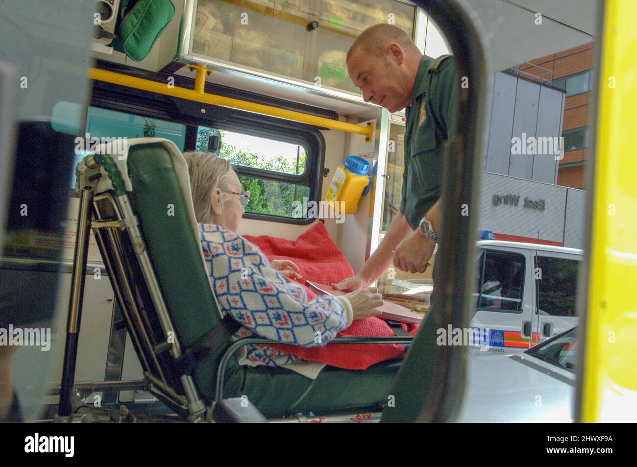 Male paramedic providing care to elderly female patient.(MODEL RELEASED ...