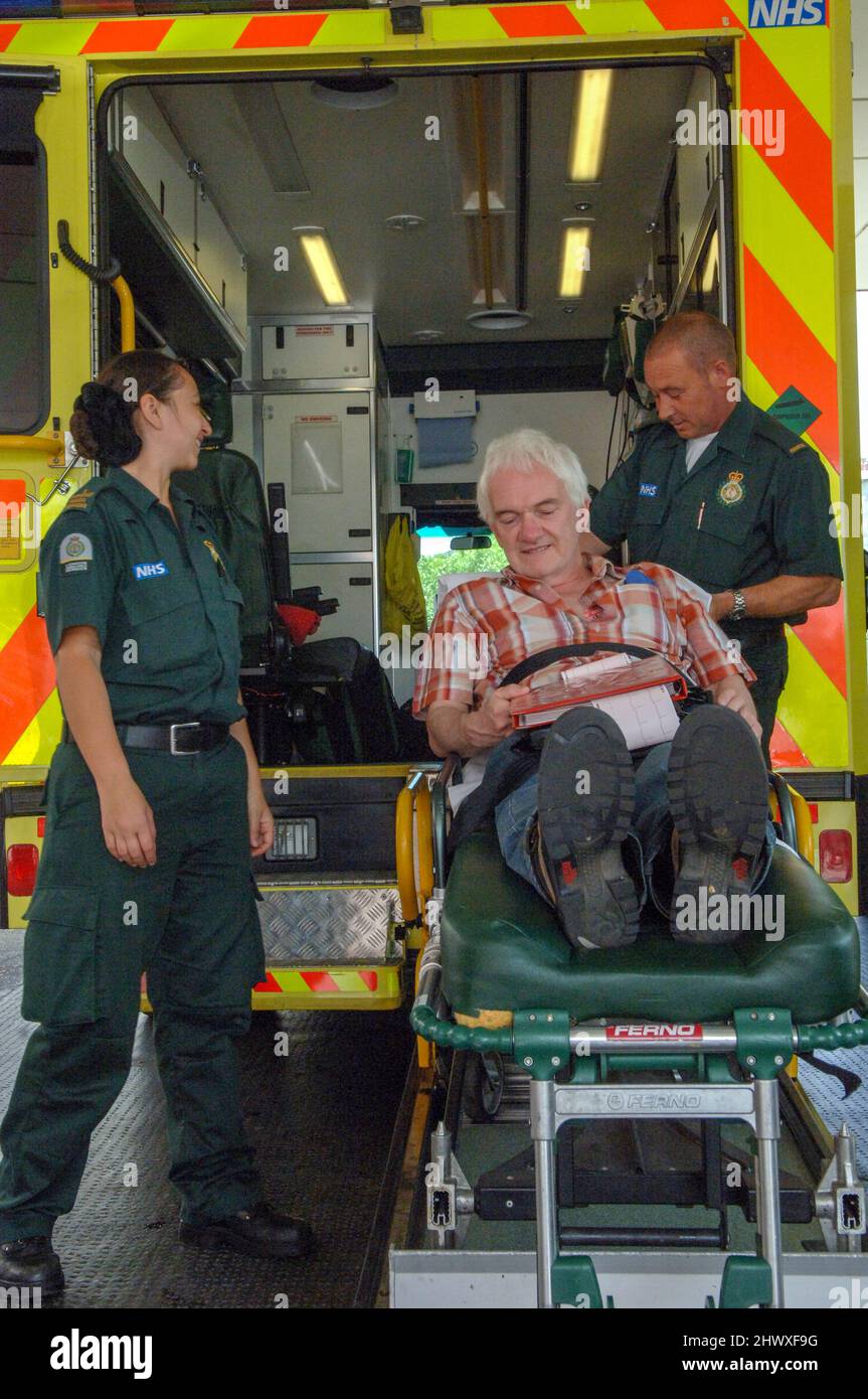 Paramedics load an elderly patient onto an ambulance.(MODEL RELEASED ...