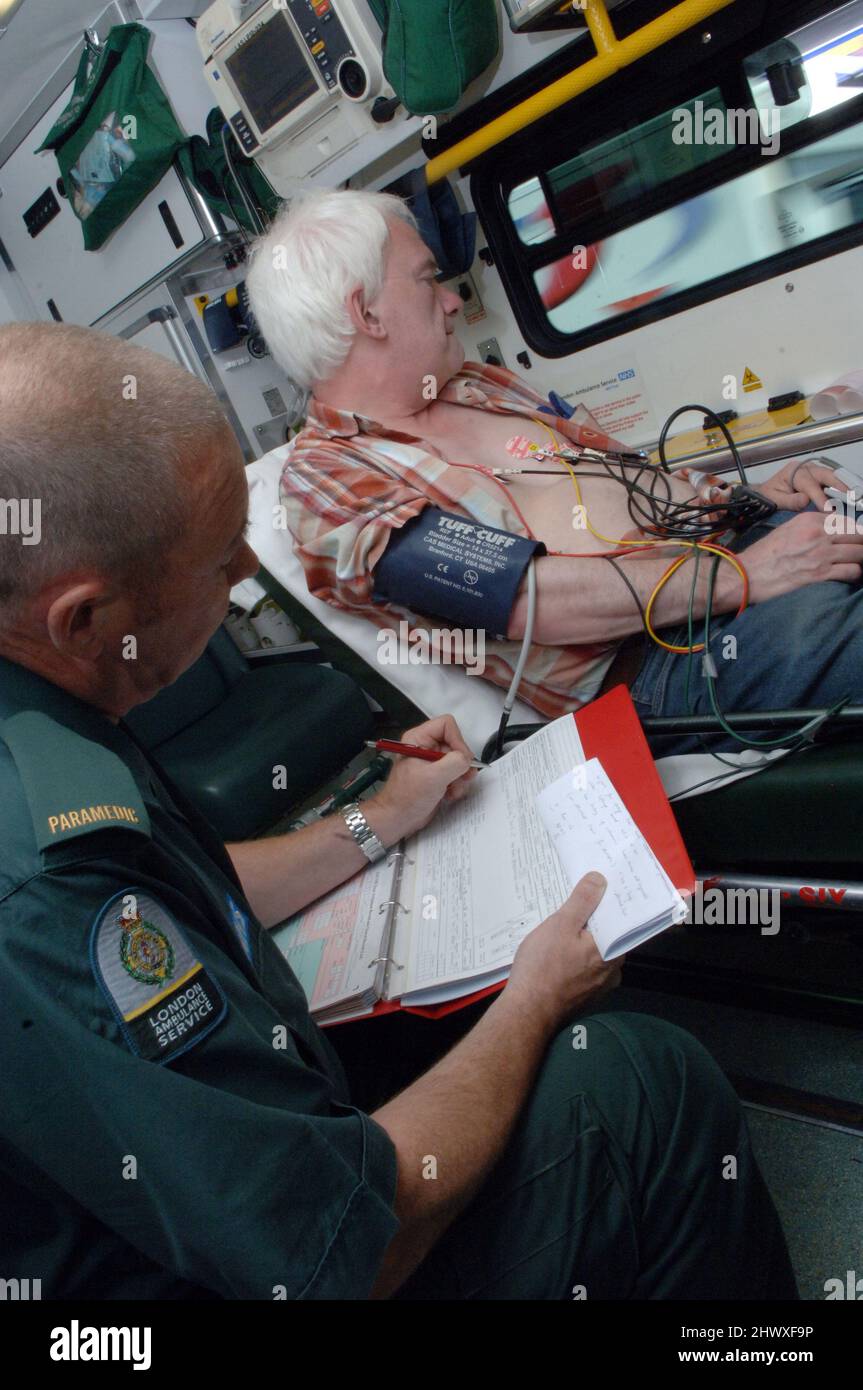 Paramedic taking notes from patient.((MODEL RELEASED Stock Photo - Alamy