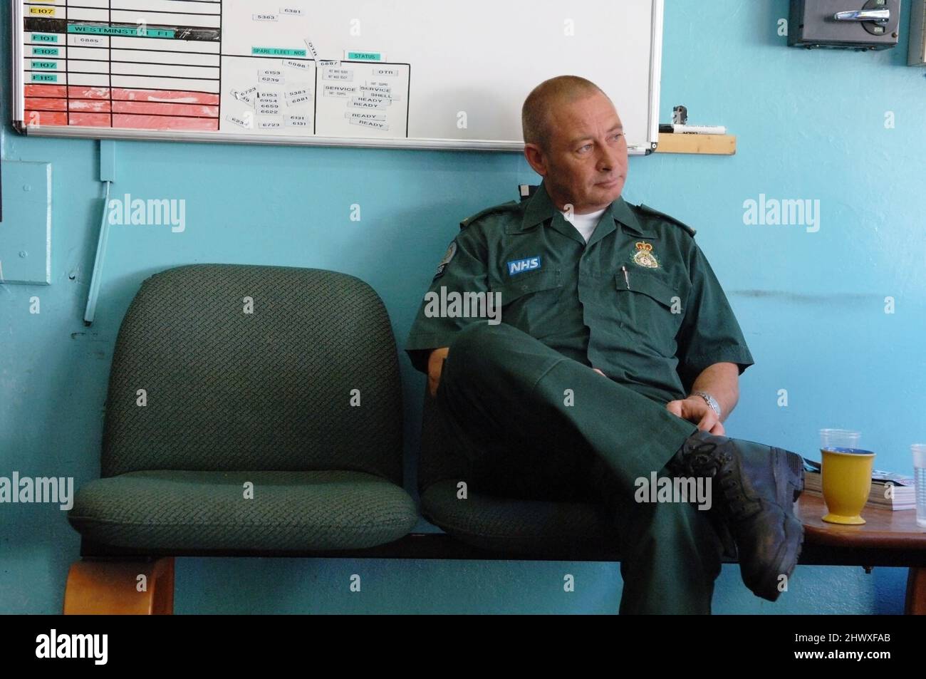 Paramedic sitting in a waiting room waiting to be called to an ...