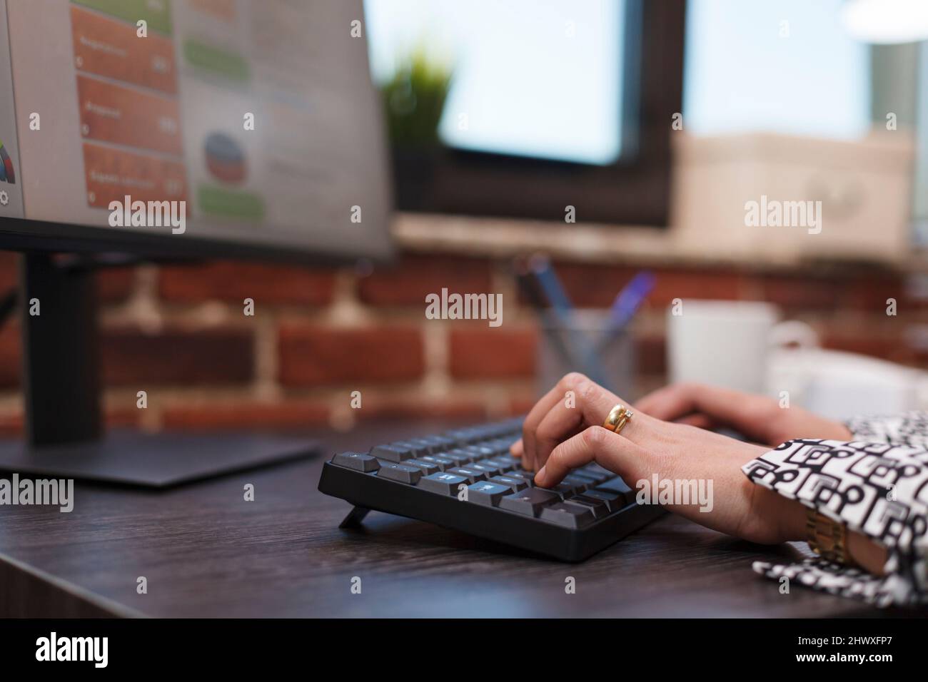 Close up of advertising agency employee hands typing on keyboard and ...