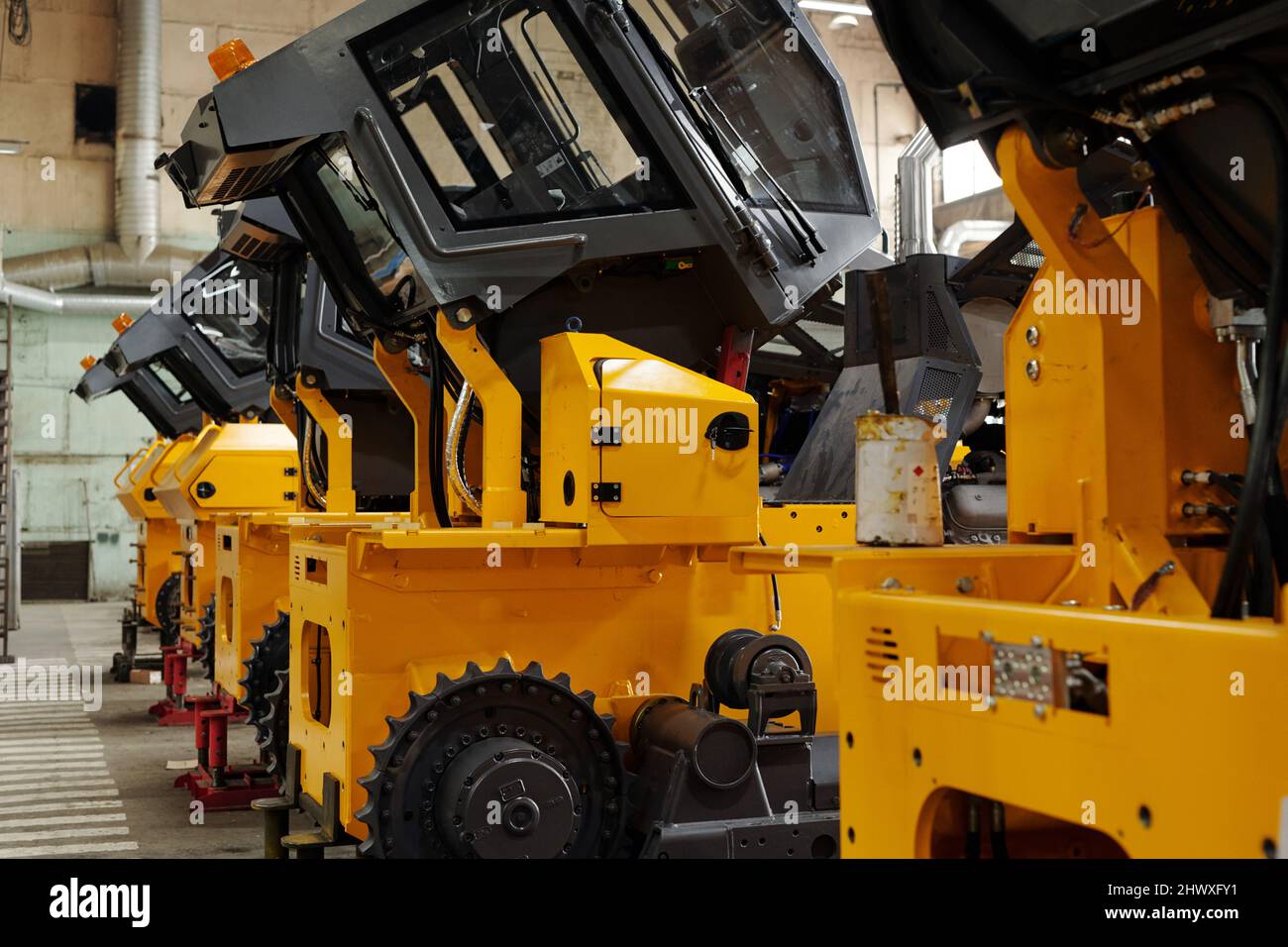 Perspective of several huge industrial machines of yelloe color ...
