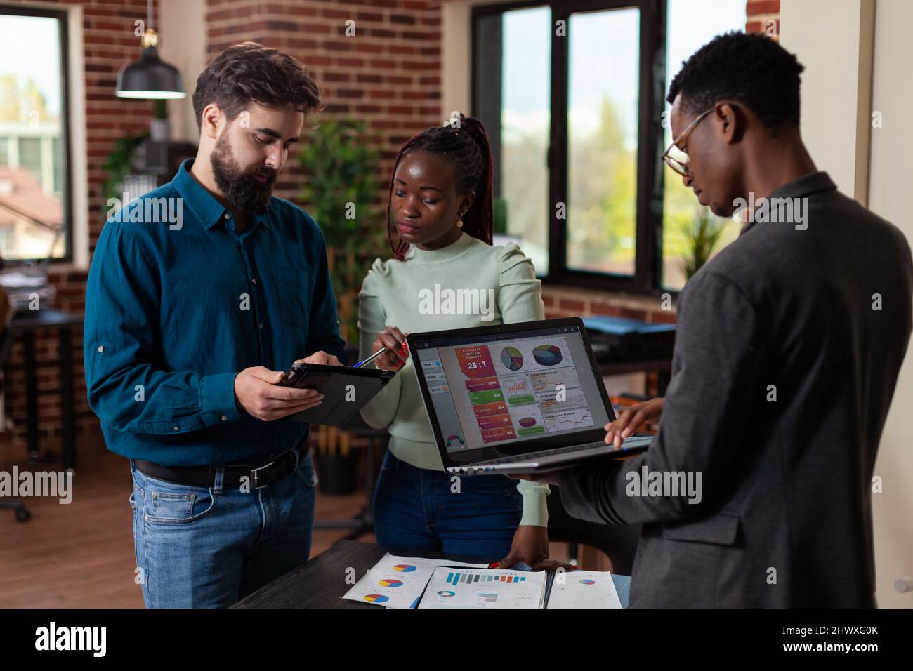 Diverse businesspeople analyzing company turnover discussing business ...