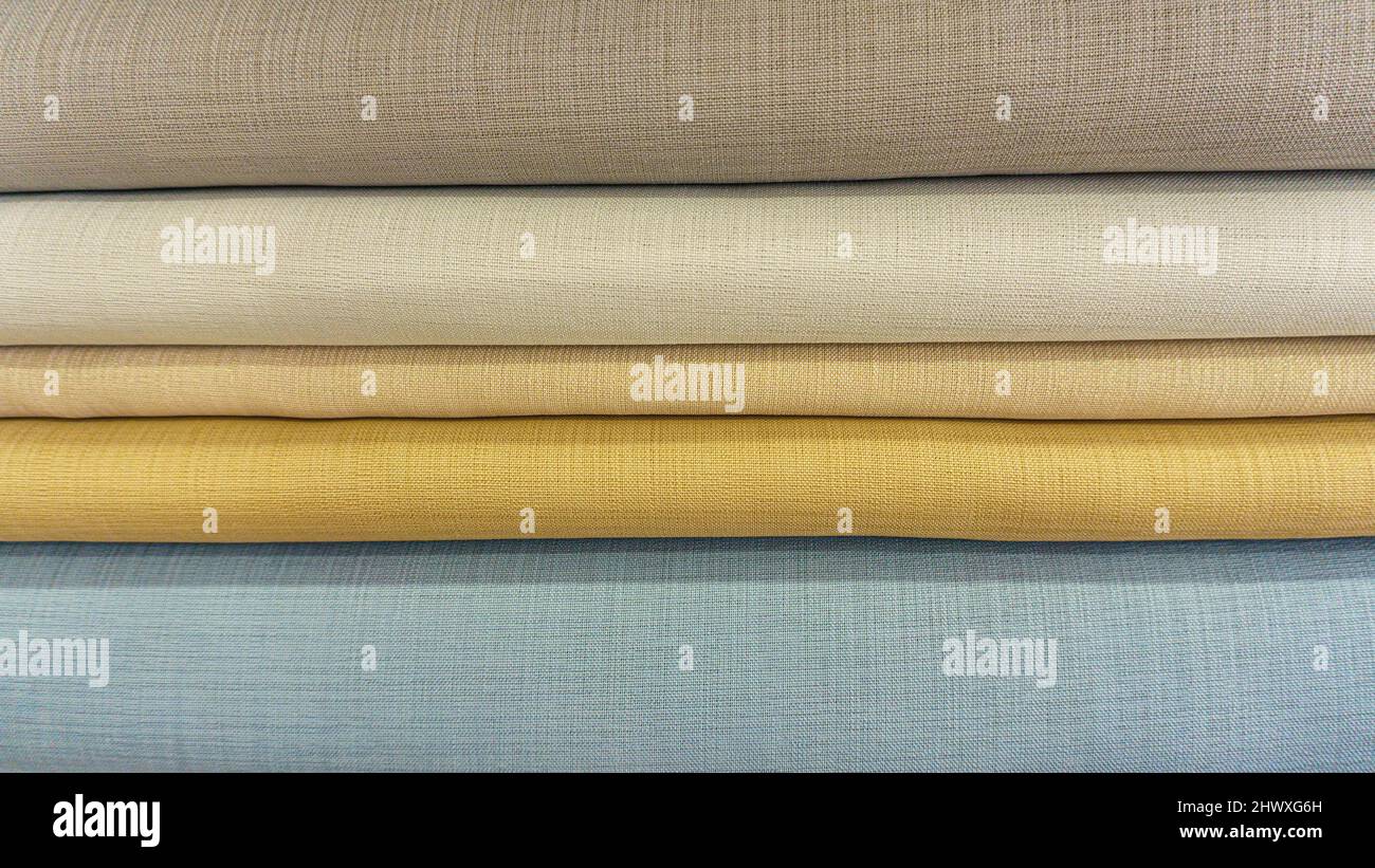 Stack of folded colorful fabric in draper or clothing store, folded ...