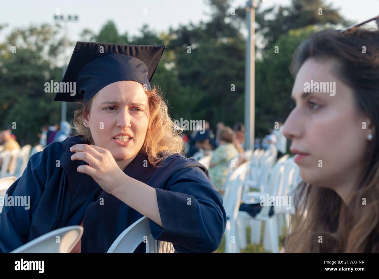 Sisters arguing at graduation celebration. One of them is graduated ...