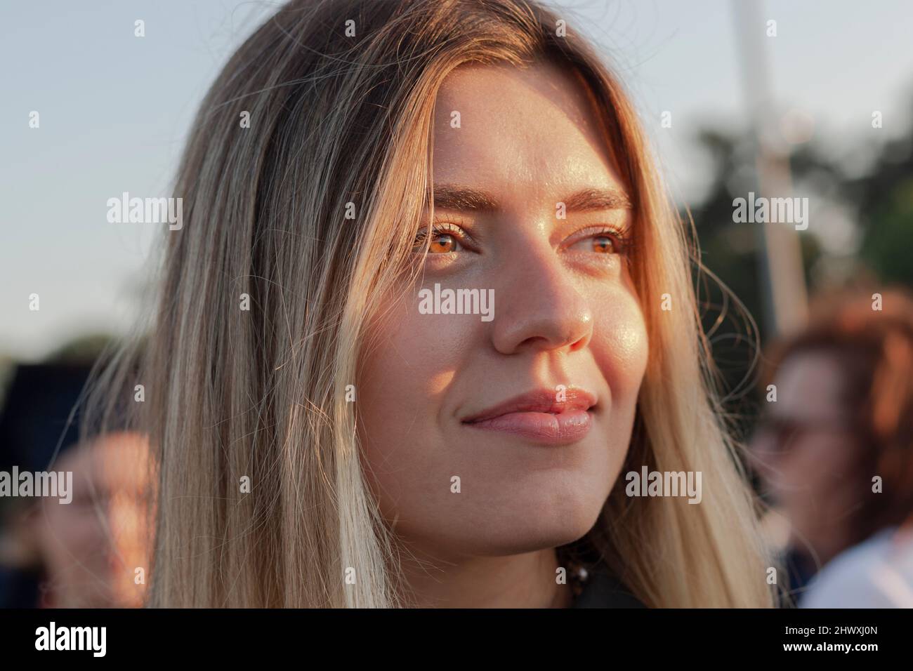 Portrait of a woman. Close up photo. She looks forward and smiling ...