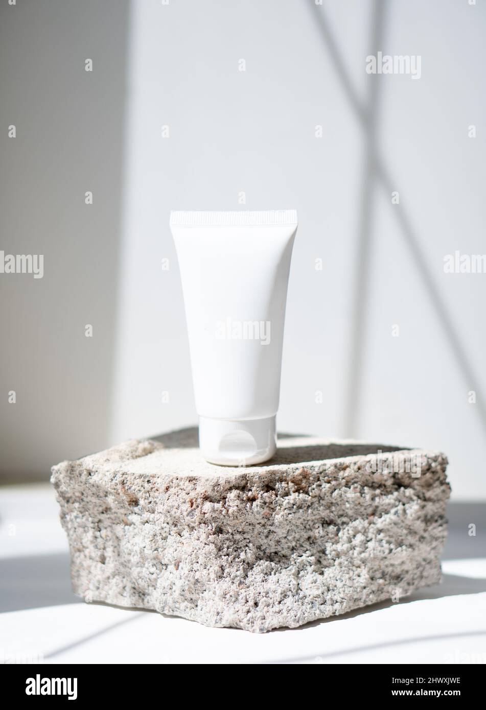 Clean white cream tube with trendy shadows and stone texture Stock ...