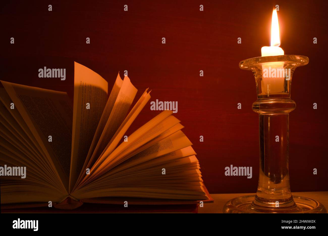 Open book, hardback book with a candle. Literature,education,reading ...