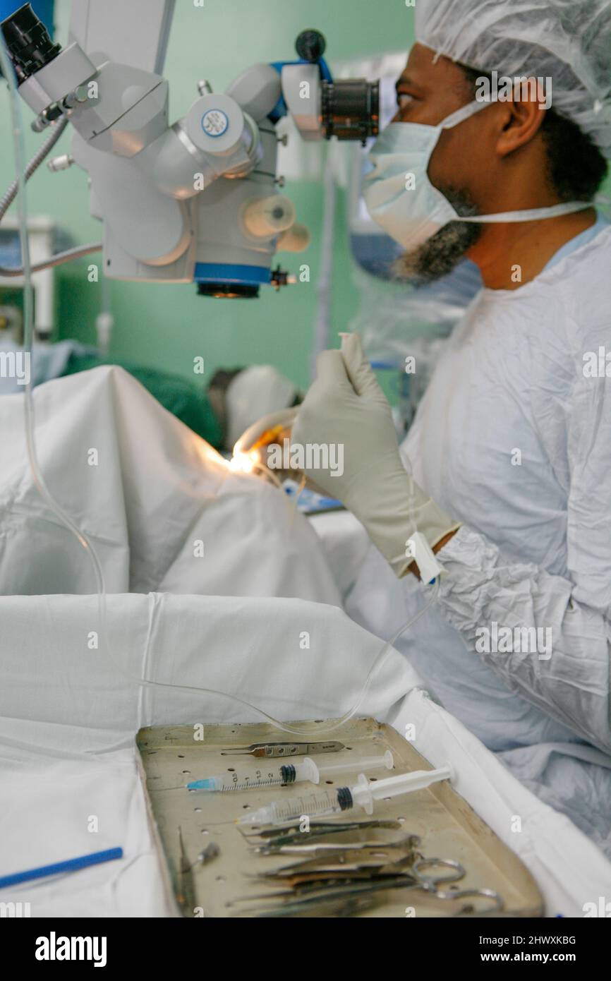 A surgeon uses a microscope during cataract surgery. The microscope ...