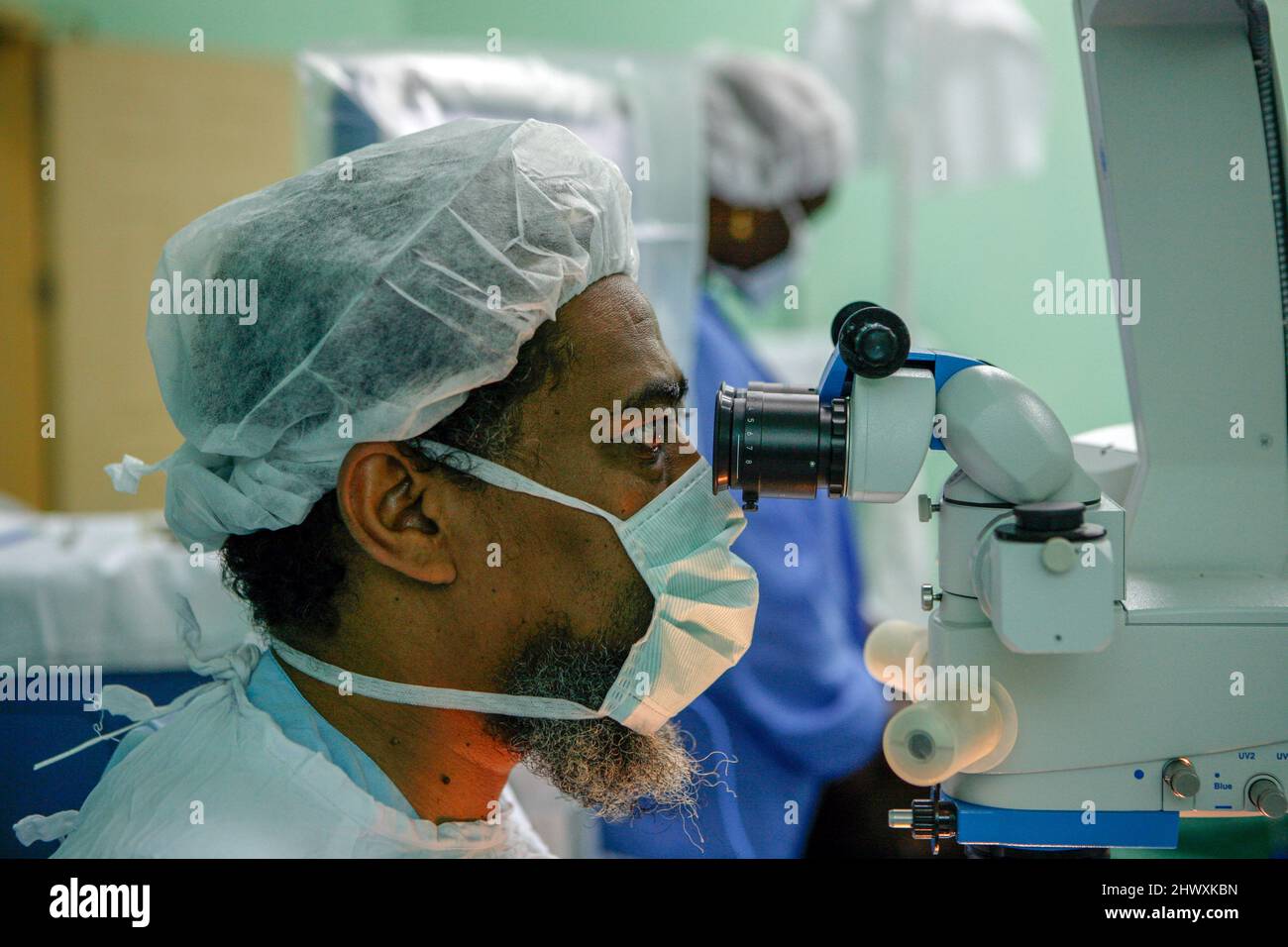 A surgeon uses a microscope during cataract surgery. The microscope ...