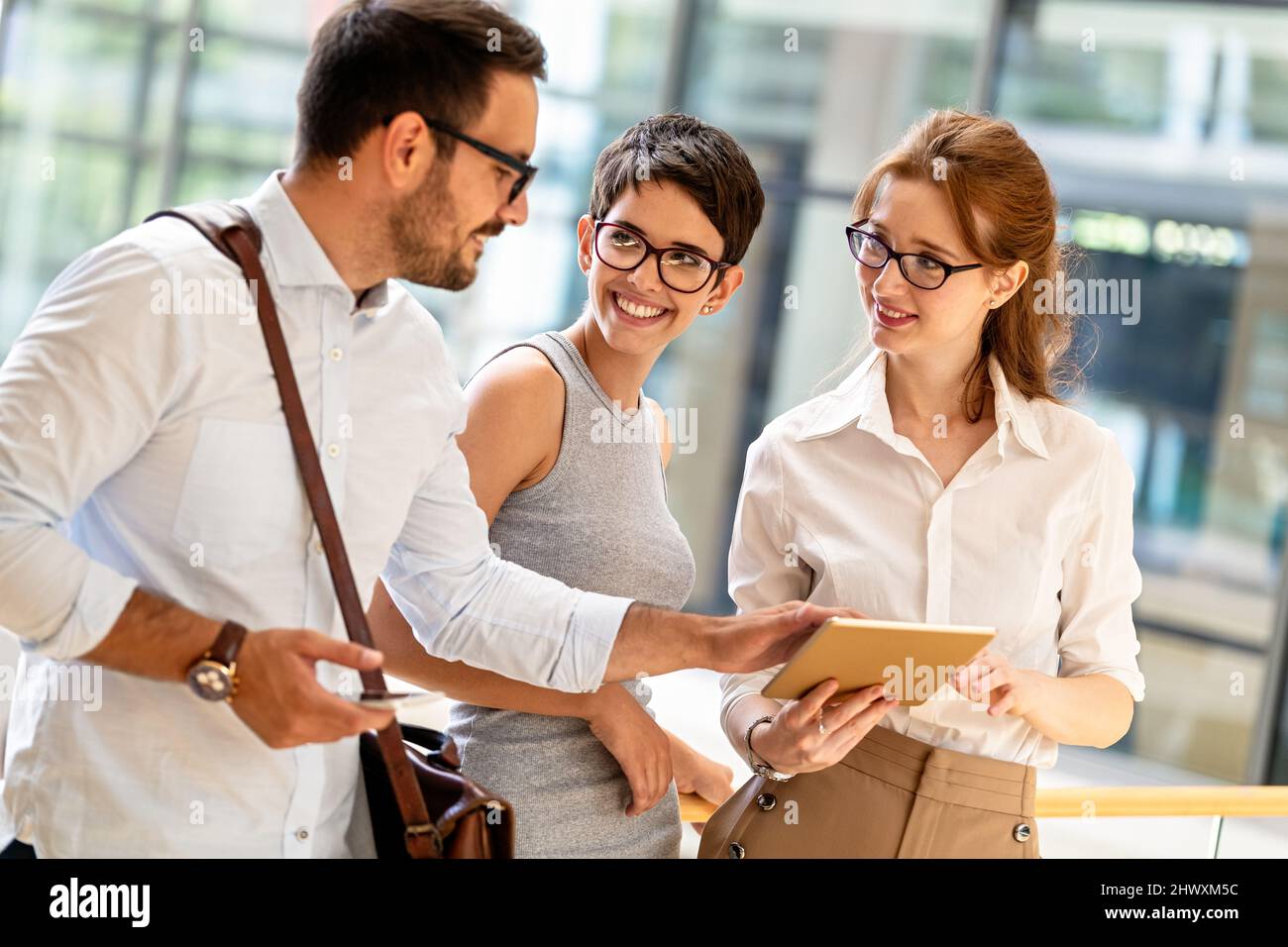 Business people having fun, teamwork and chatting at workplace office ...