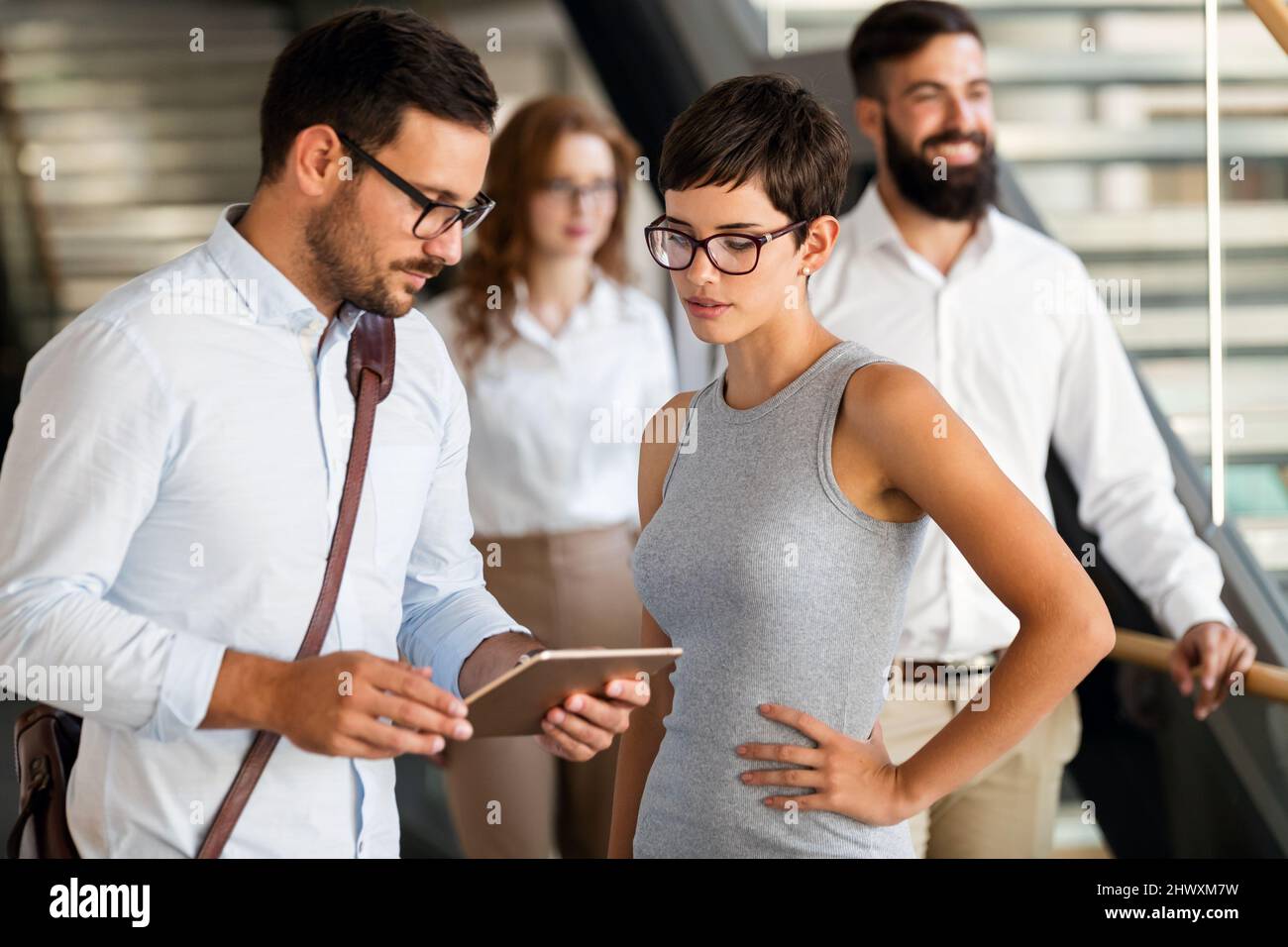 Business people having fun, teamwork and chatting at workplace office ...