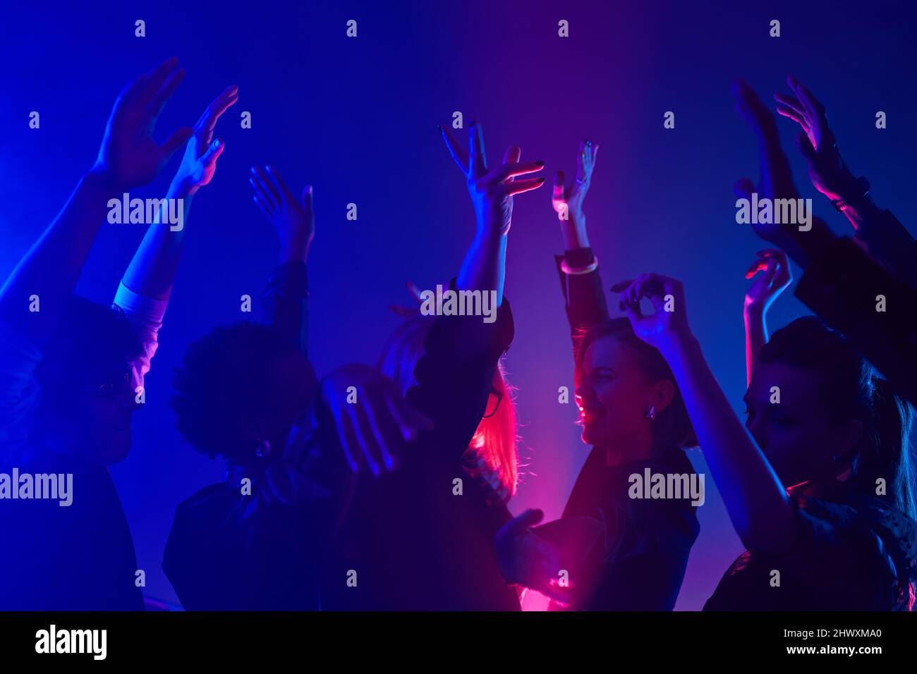Crowd with raised up hands dancing in nightclub hi-res stock ...