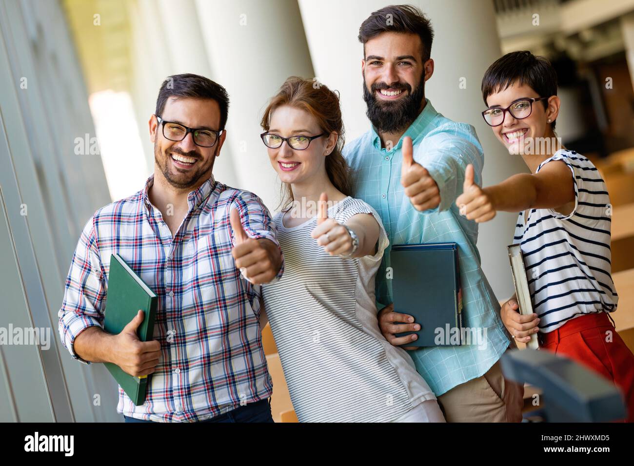 Students studying in library. Young success people are spending time ...