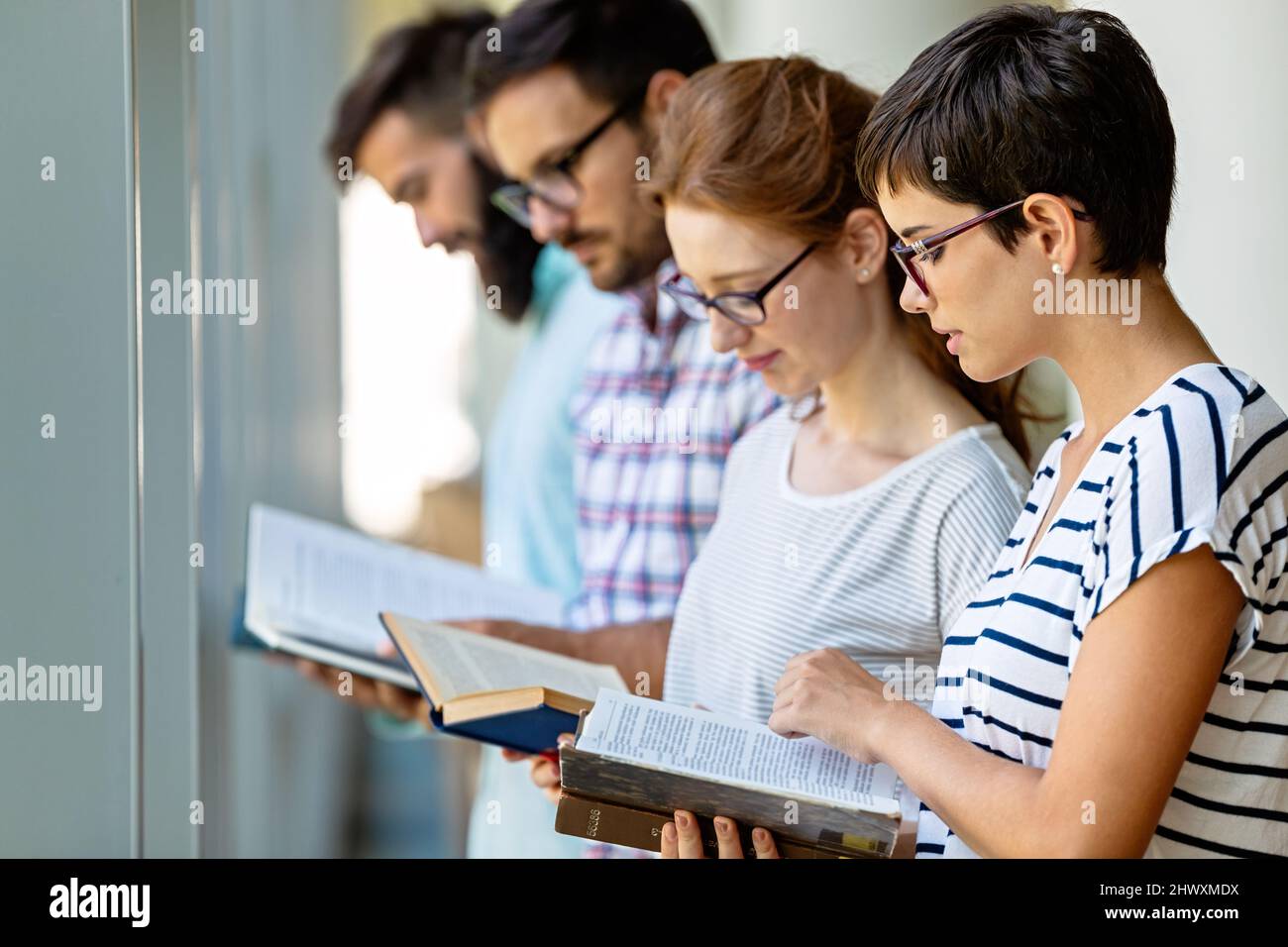 Happy group of students studying and working together in a college ...