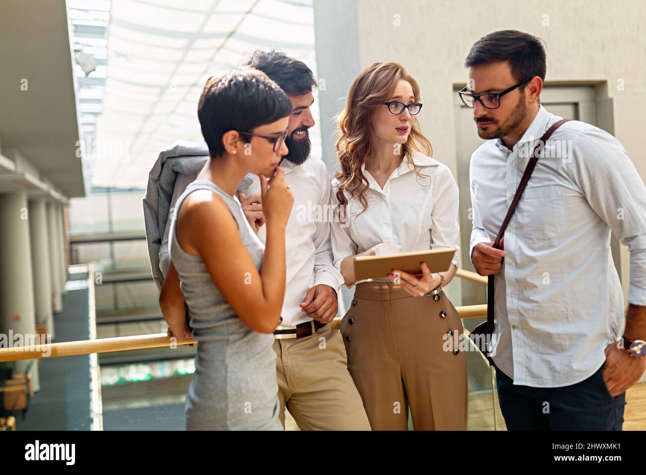 Business people having fun, teamwork and chatting at workplace office ...
