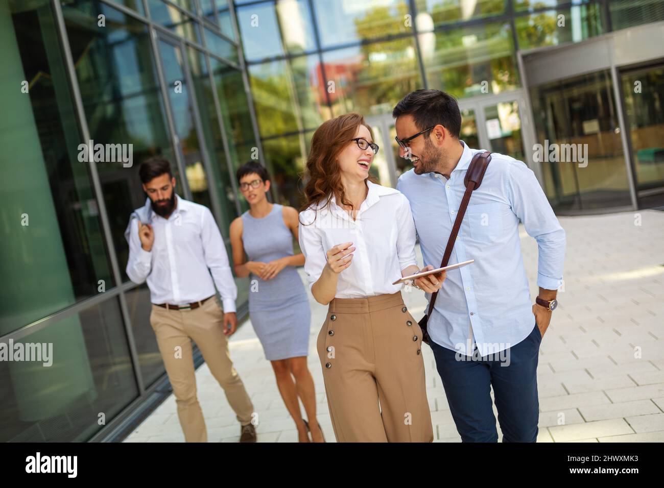 Business people having fun, teamwork and chatting at workplace office ...