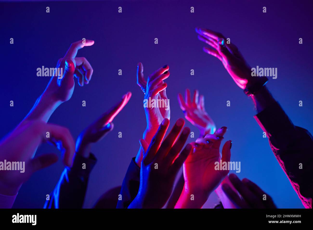 Crowd with raised up hands dancing in nightclub hi-res stock ...